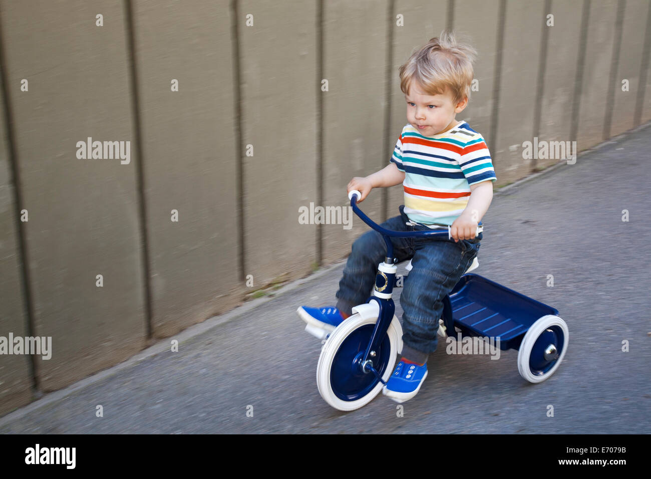 Child on tricycle hi-res stock photography and images - Alamy