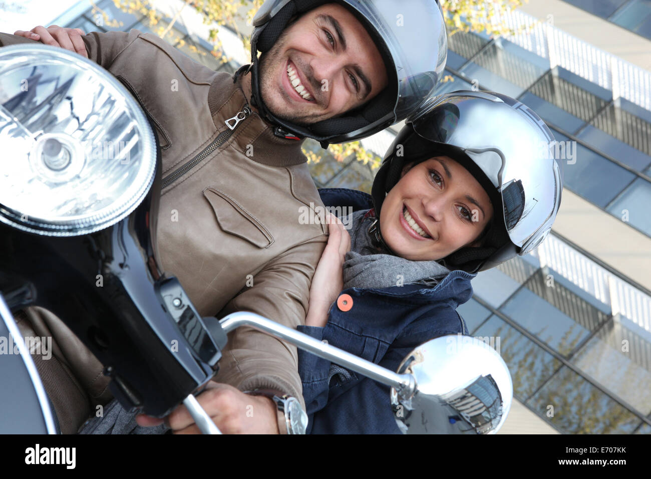 Couple riding a motor bike Stock Photo - Alamy