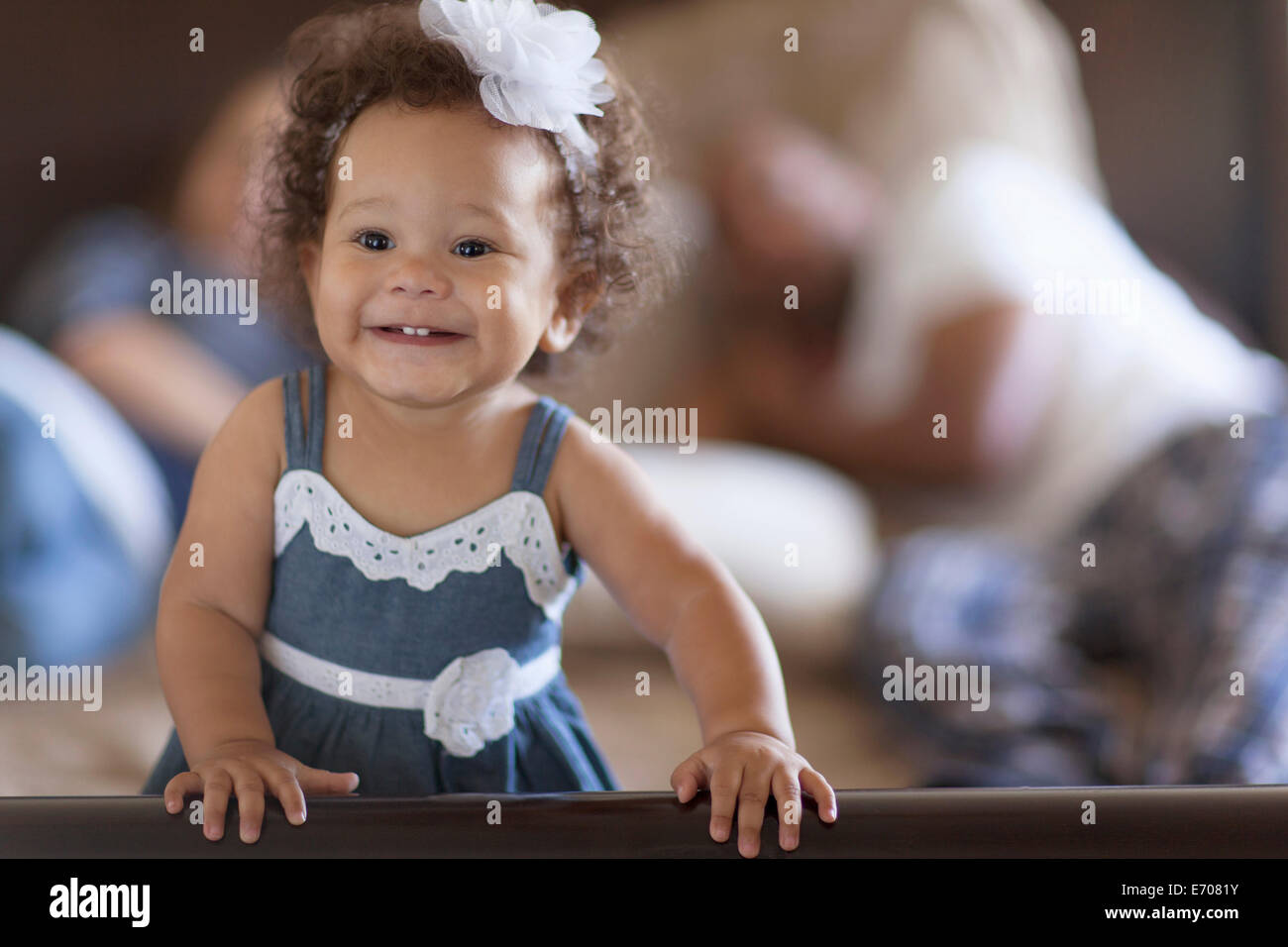 Portrait of baby girl, parents behind Stock Photo - Alamy