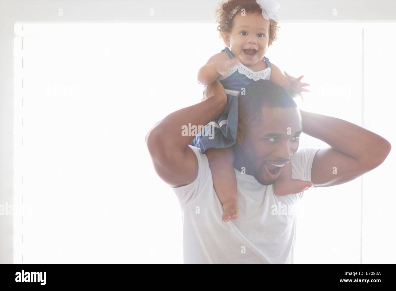Father holding baby daughter on his shoulders Stock Photo - Alamy