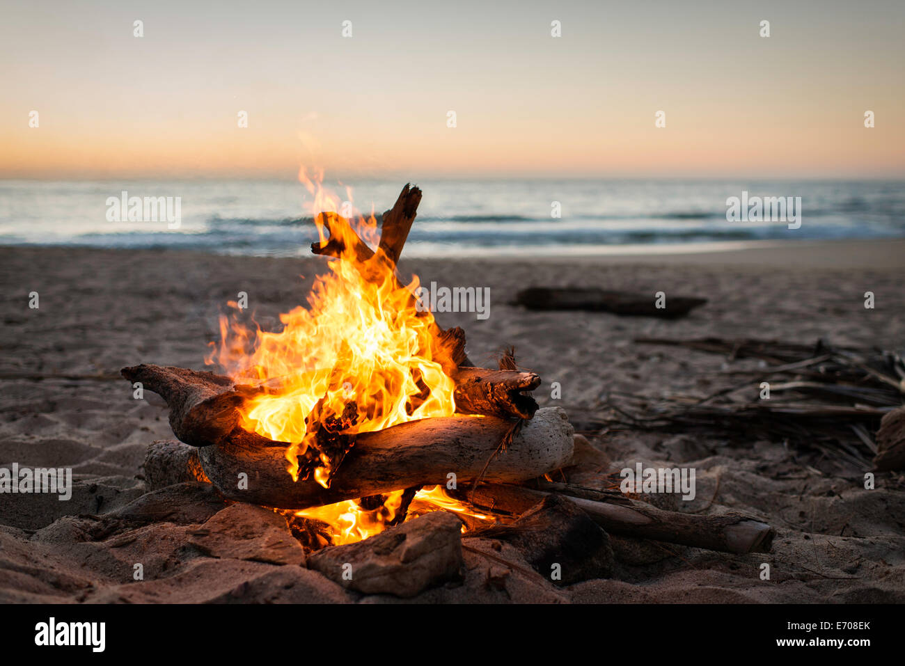 Bonfire burning on beach Stock Photo - Alamy
