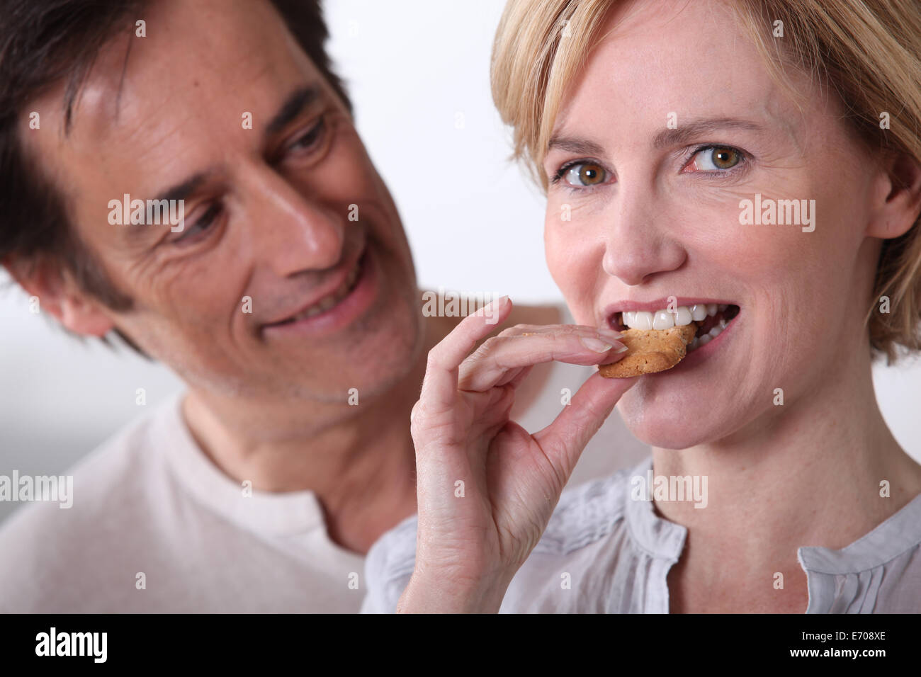 Old woman eating cookies watching hi-res stock photography and images ...