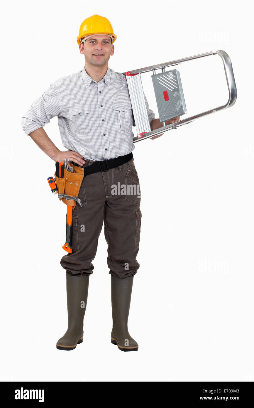 Tradesman carrying a stepladder Stock Photo - Alamy