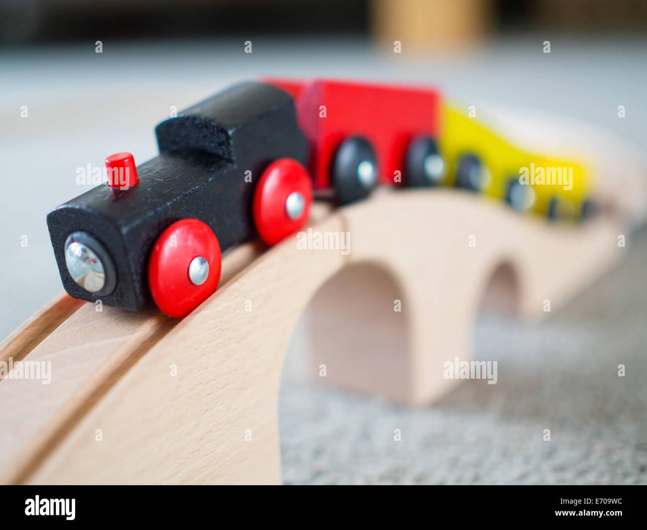 Wooden toy train over wooden toy bridge Stock Photo - Alamy