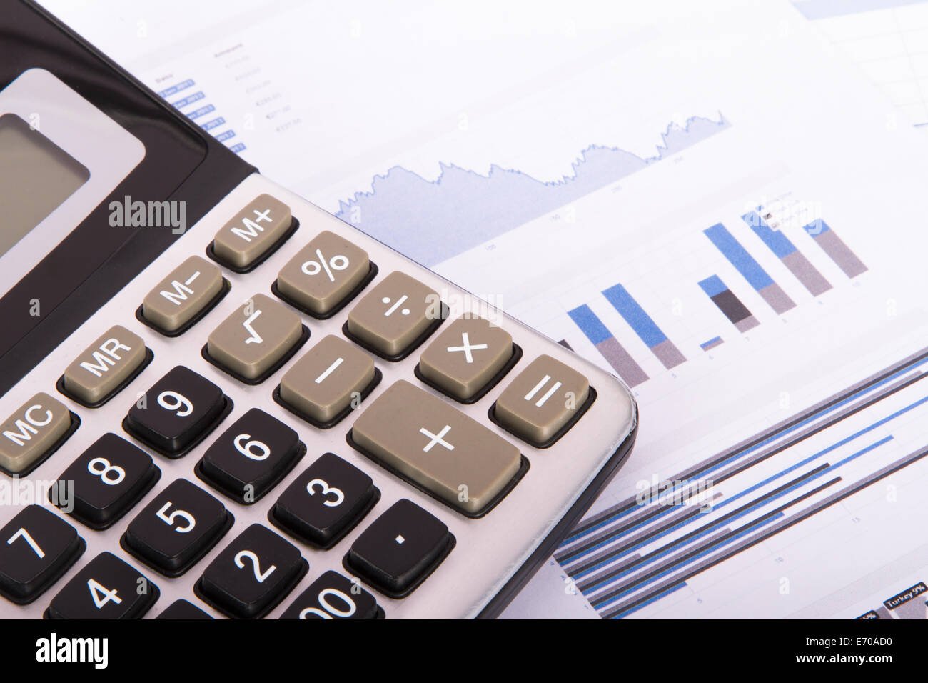 Calculator on financial data graphs Stock Photo - Alamy