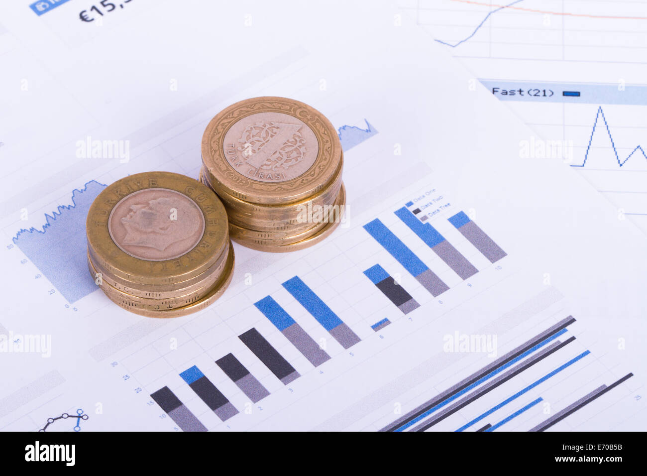 Coins on chart graphs and financial data analysis Stock Photo - Alamy