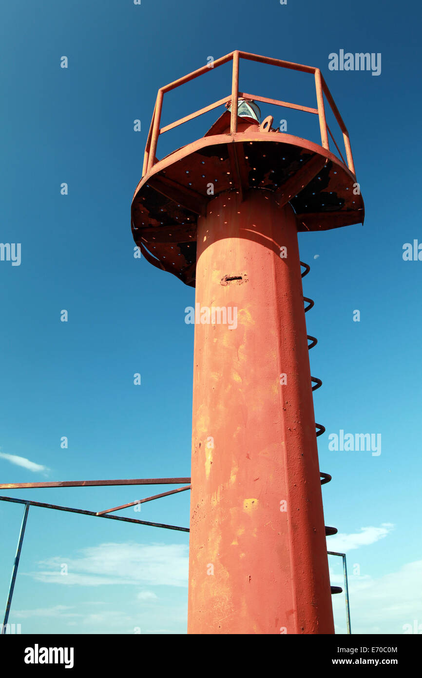 Small red lighthouse pole above deep blue sky Stock Photo - Alamy