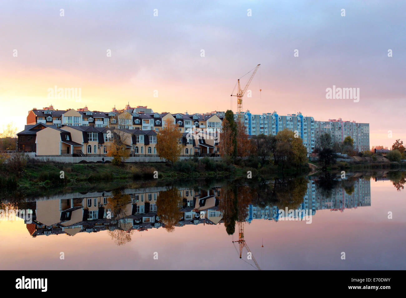 beautiful landscape with sunset, river and modern house reflecting in ...