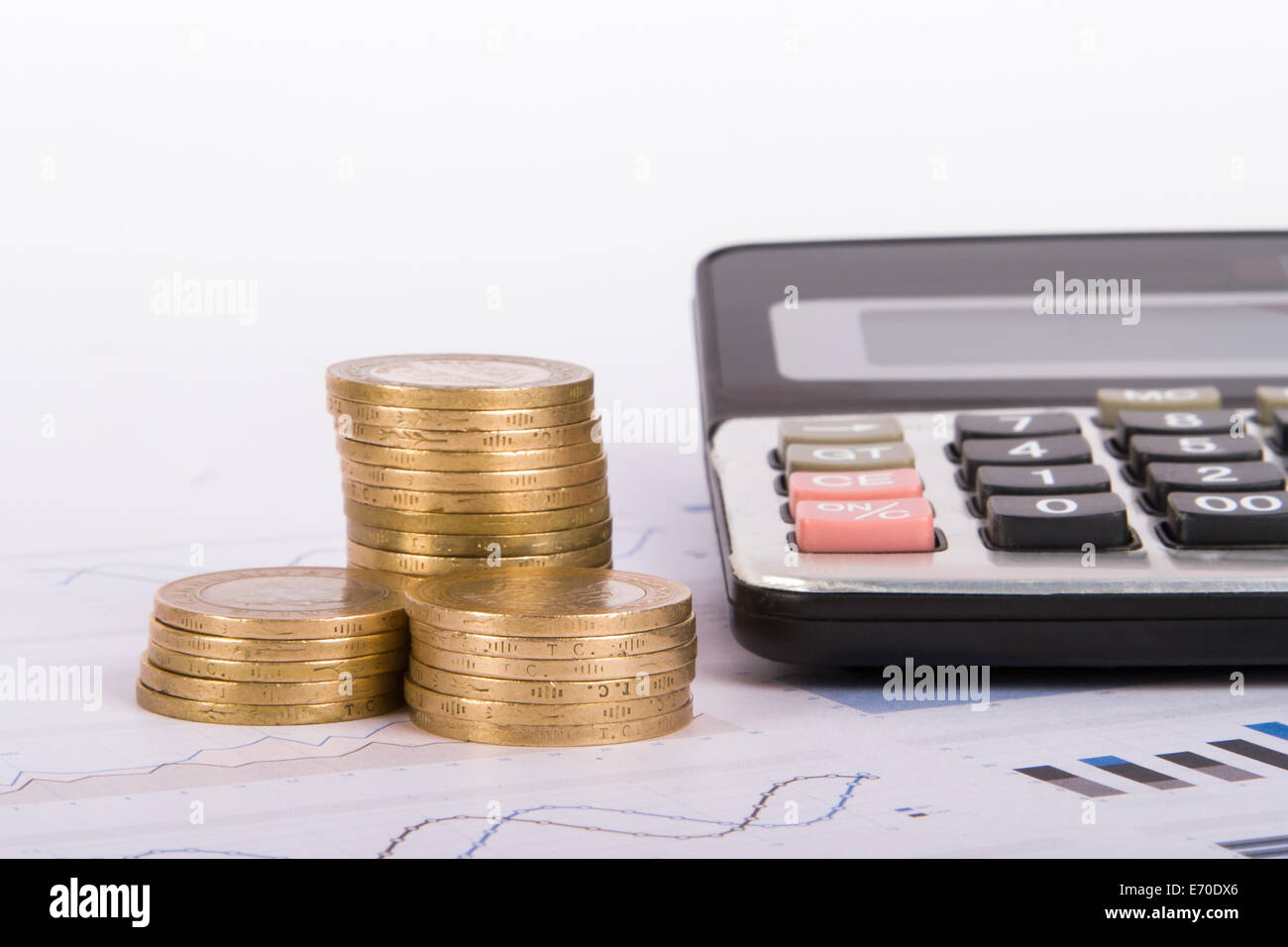 Money and calculator on financial data bar charts Stock Photo - Alamy