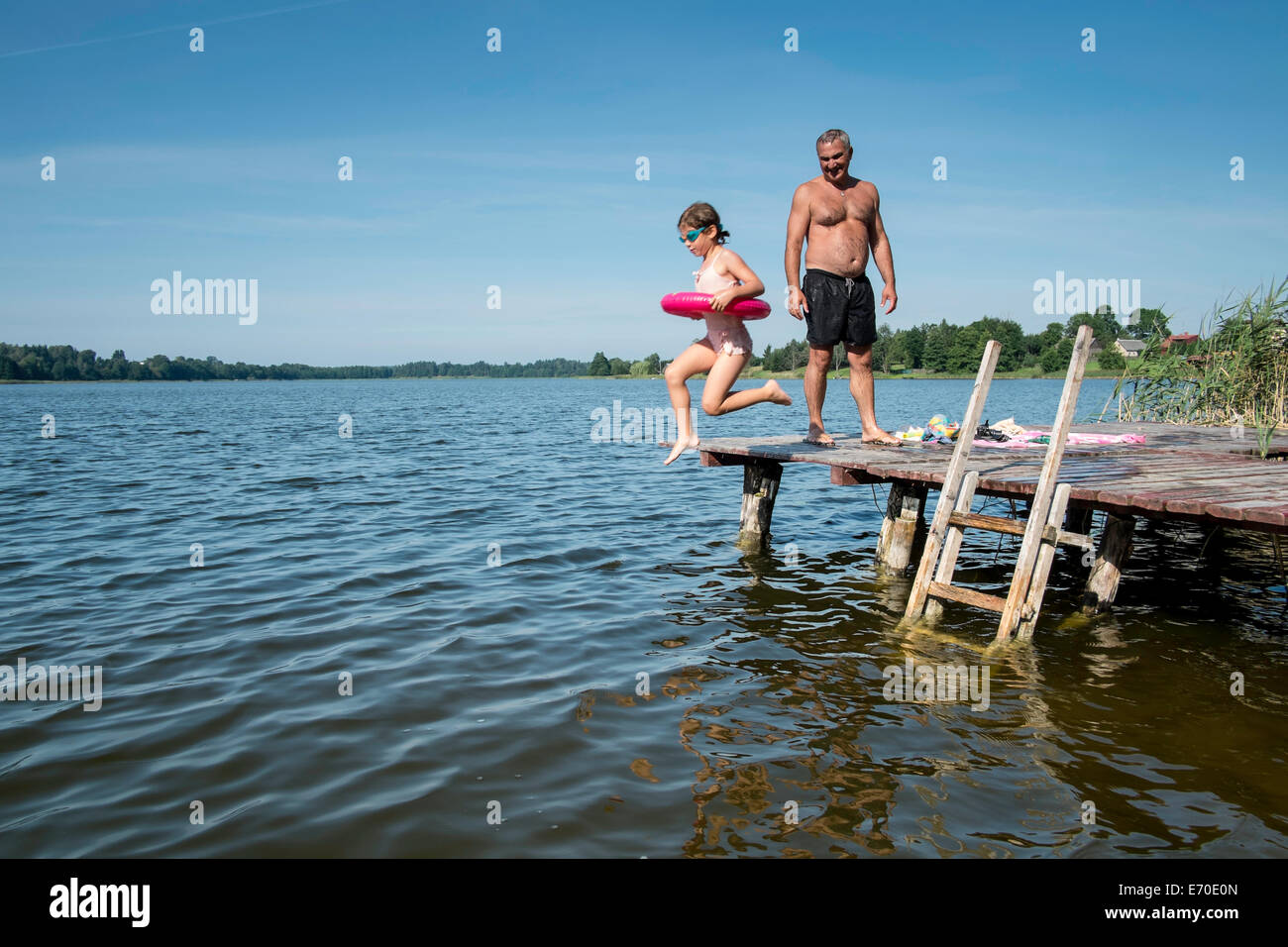 Family enjoying a swim in Gieret Lake, Giby, Suwalskie Region, Poland ...