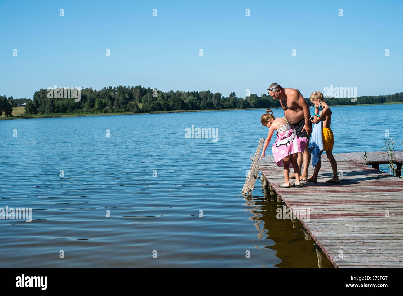 Family enjoying a swim, Gieret Lake, Giby, Poland Stock Photo - Alamy