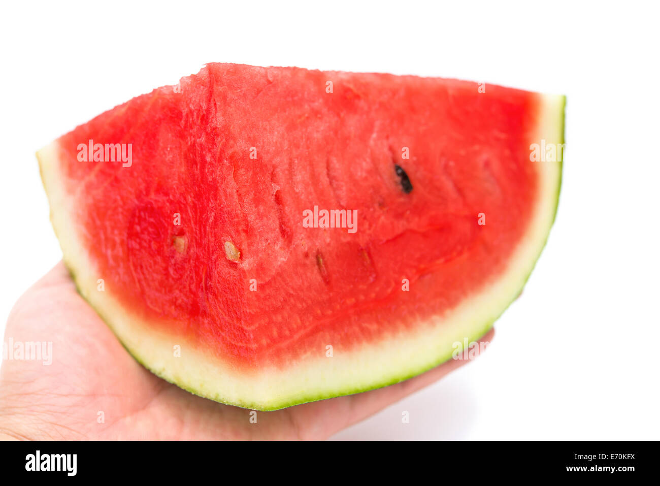 hand holding a piece of watermelon on a white background Stock Photo ...