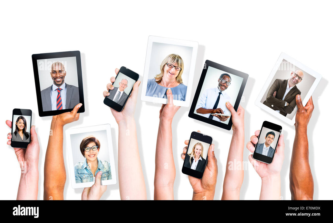 Hands Holding Digital Devices with Business People Stock Photo - Alamy