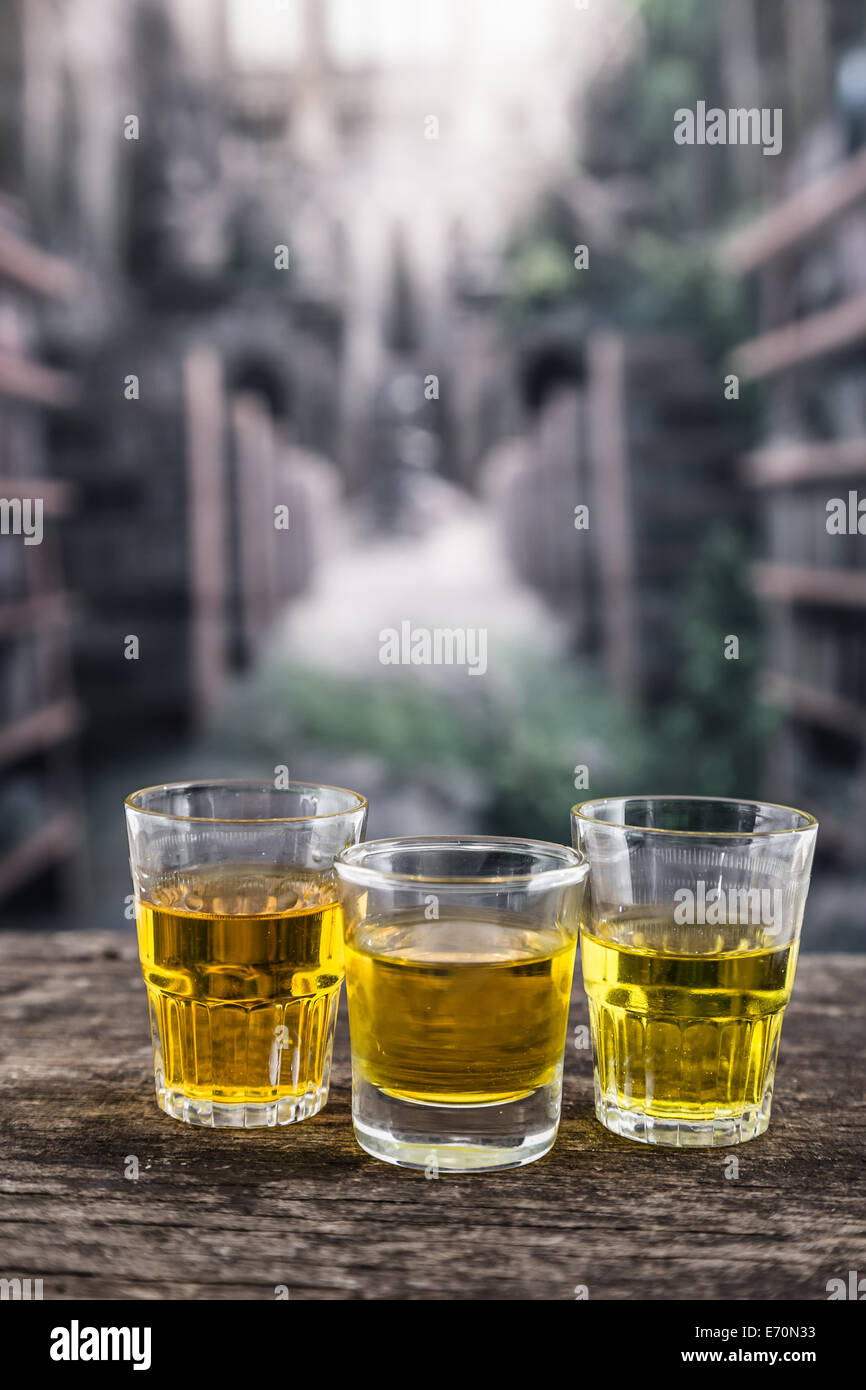 glass shots with yellow liqour resembling whiskey, rum, tequila, spirit ...