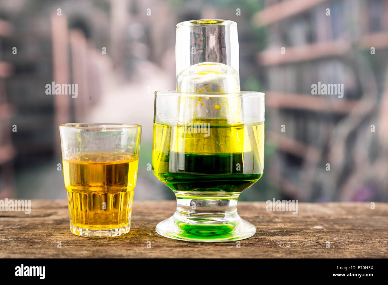 Yellow green cocktail inside a glass and shot Stock Photo - Alamy