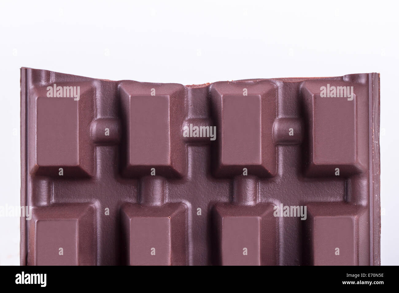 Close up view of broken milk chocolate bar piece, isolated on white ...