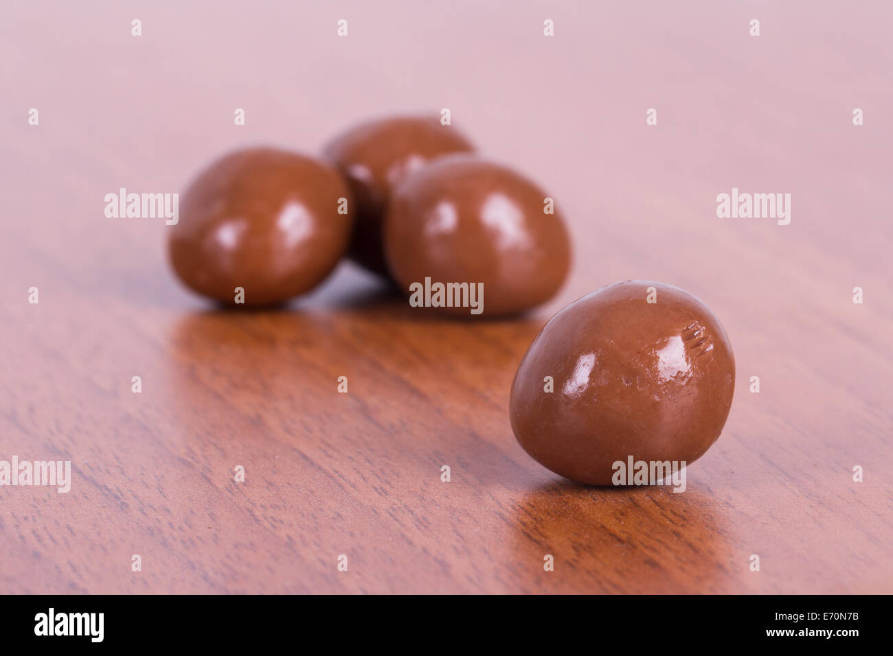 Round milk chocolate on wooden table Stock Photo - Alamy