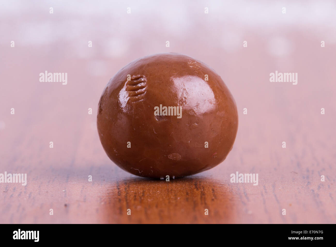 Single round milk chocolate candy Stock Photo - Alamy