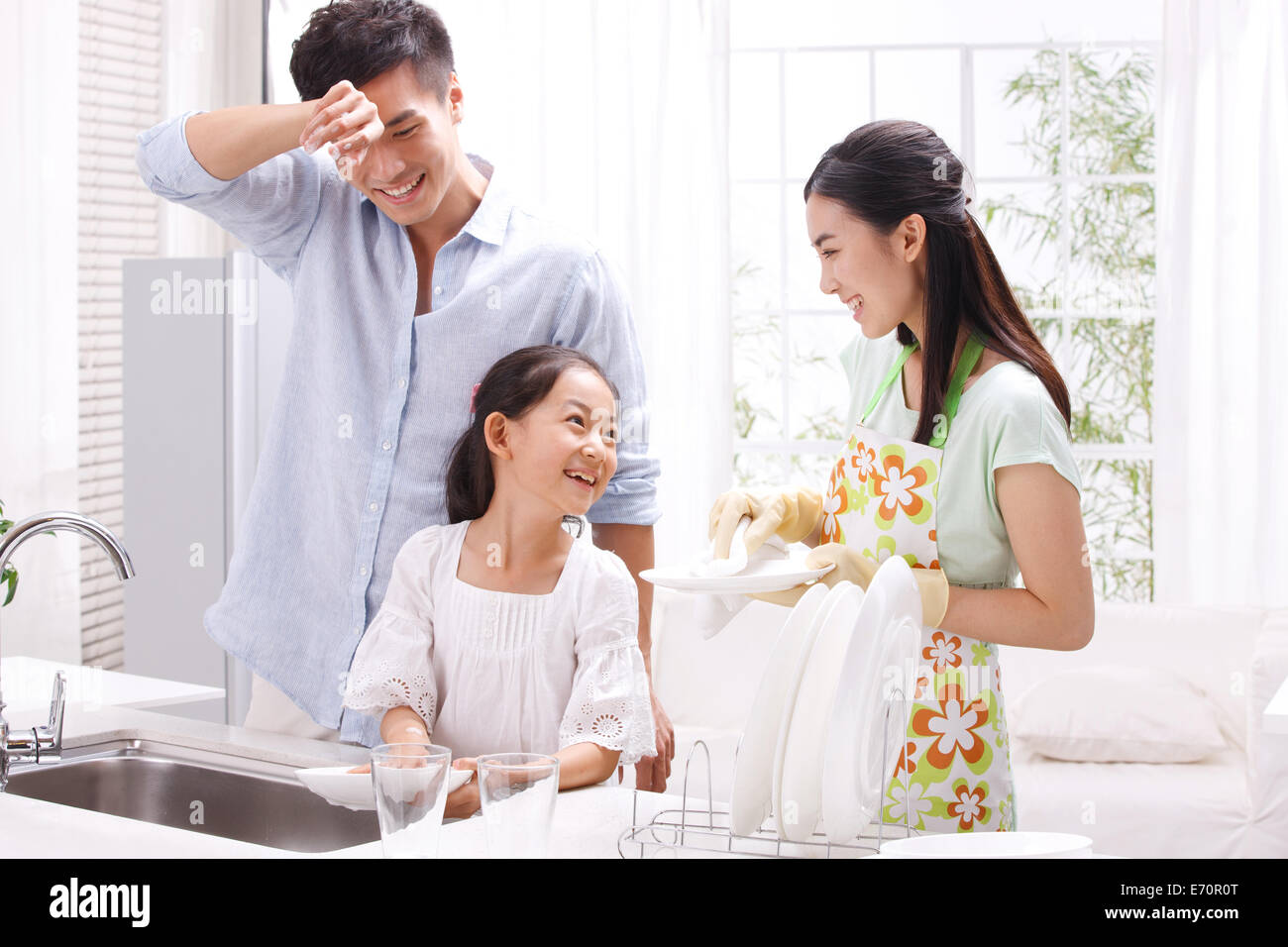 Family washing dishes in kitchen Stock Photo - Alamy