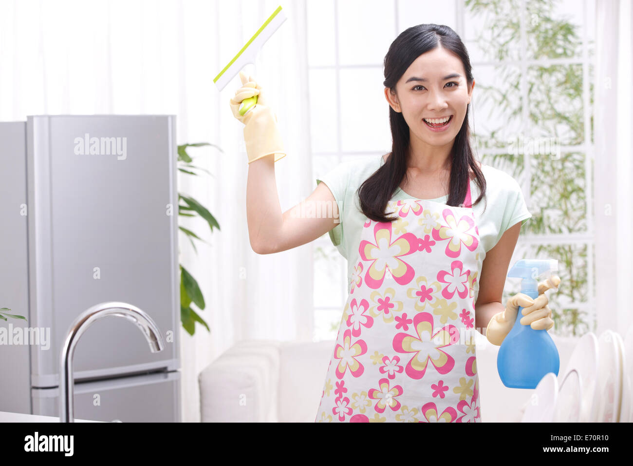 Young woman cleaning kitchen Stock Photo - Alamy