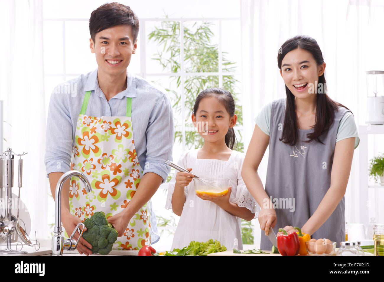 Family cooking in kitchen Stock Photo - Alamy