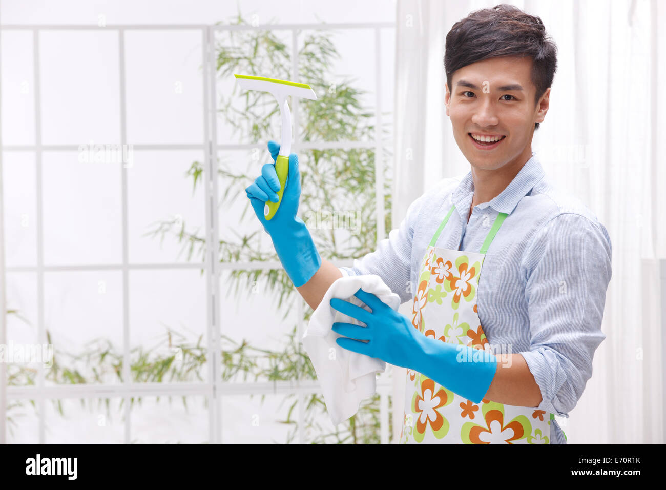 Young man cleaning room Stock Photo - Alamy