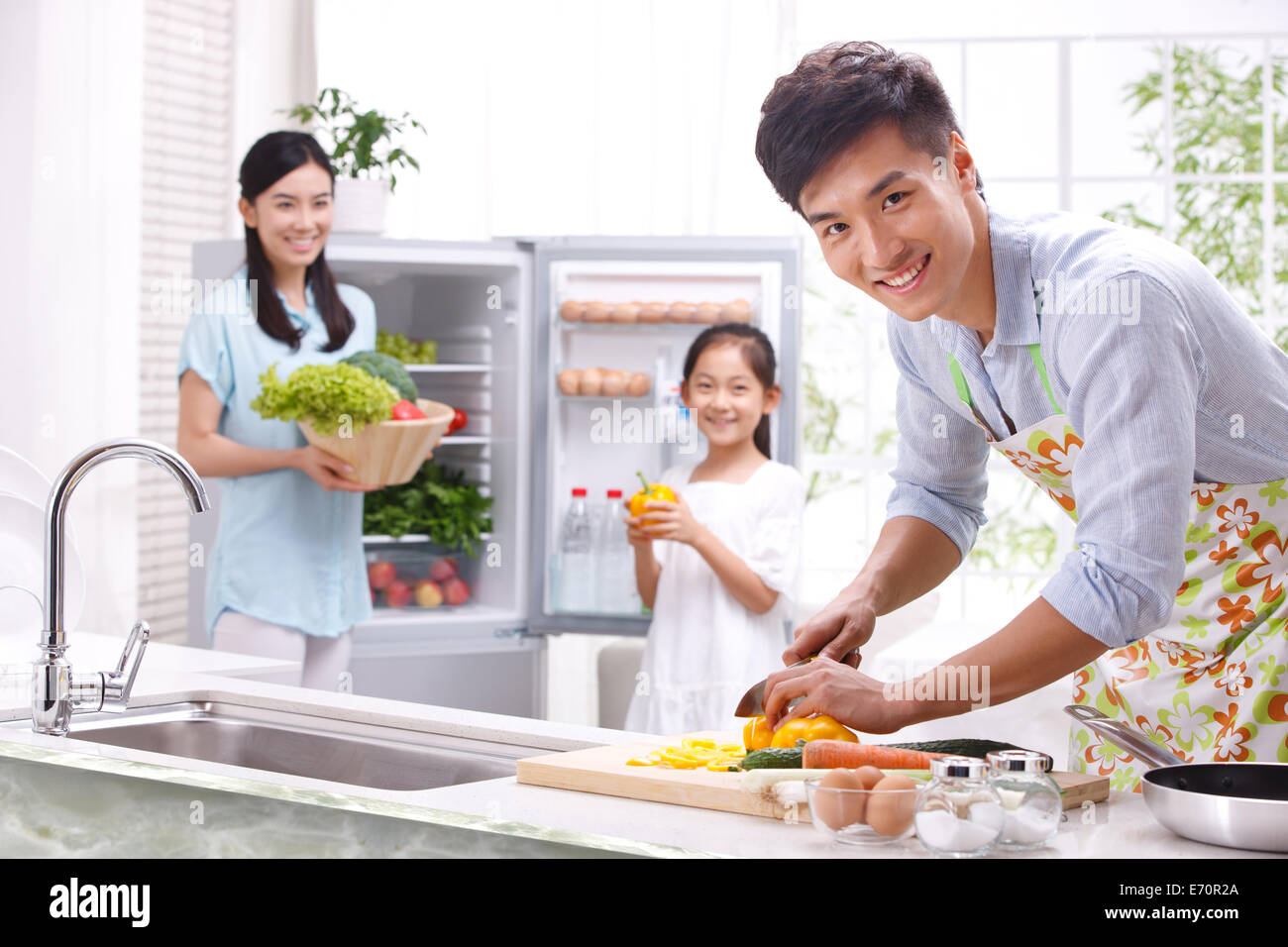 Family cooking in kitchen Stock Photo - Alamy