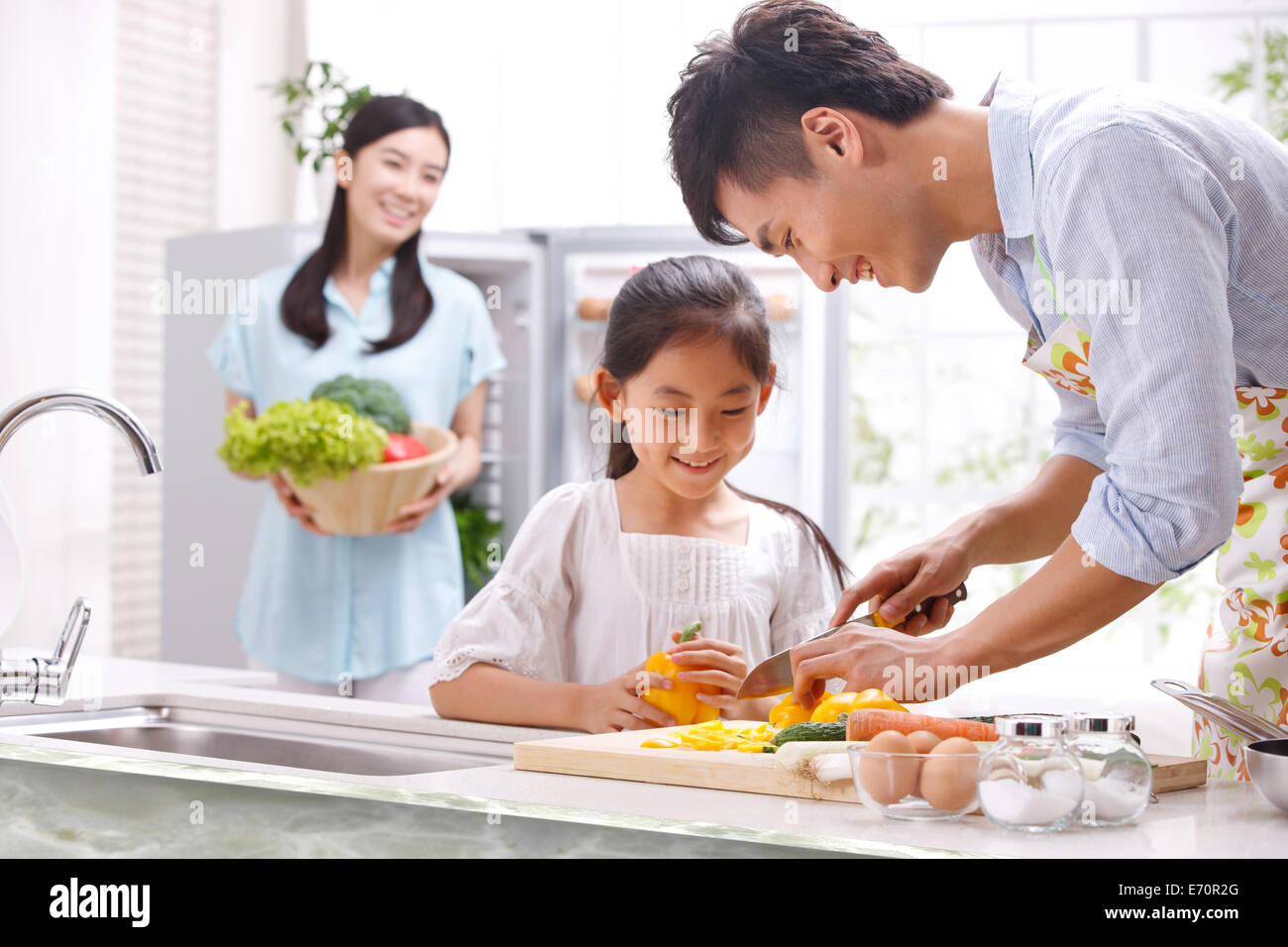 Family cooking in kitchen Stock Photo - Alamy