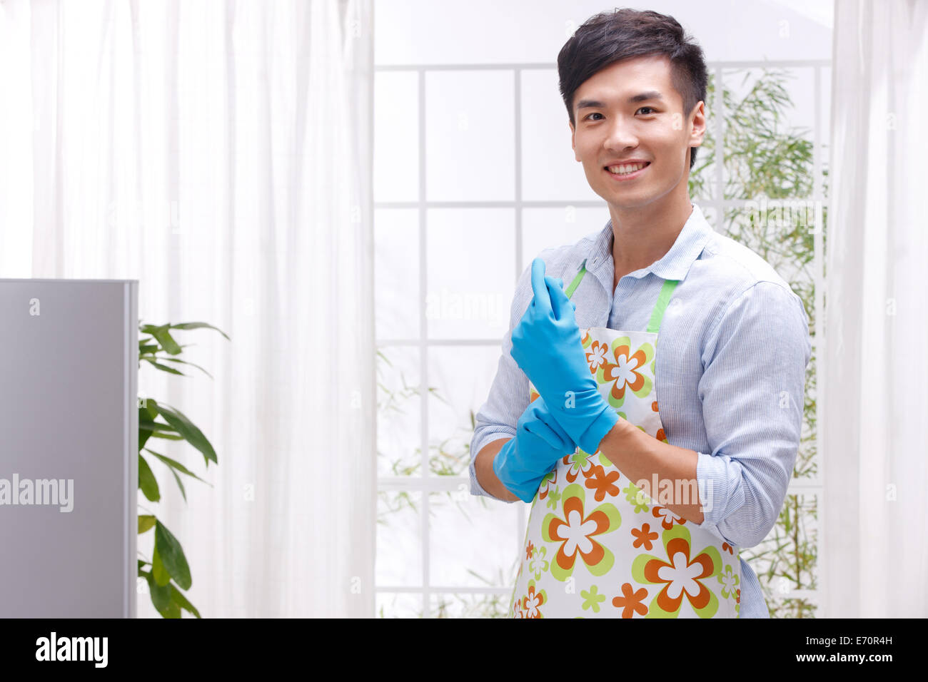 Young man cleaning room Stock Photo - Alamy