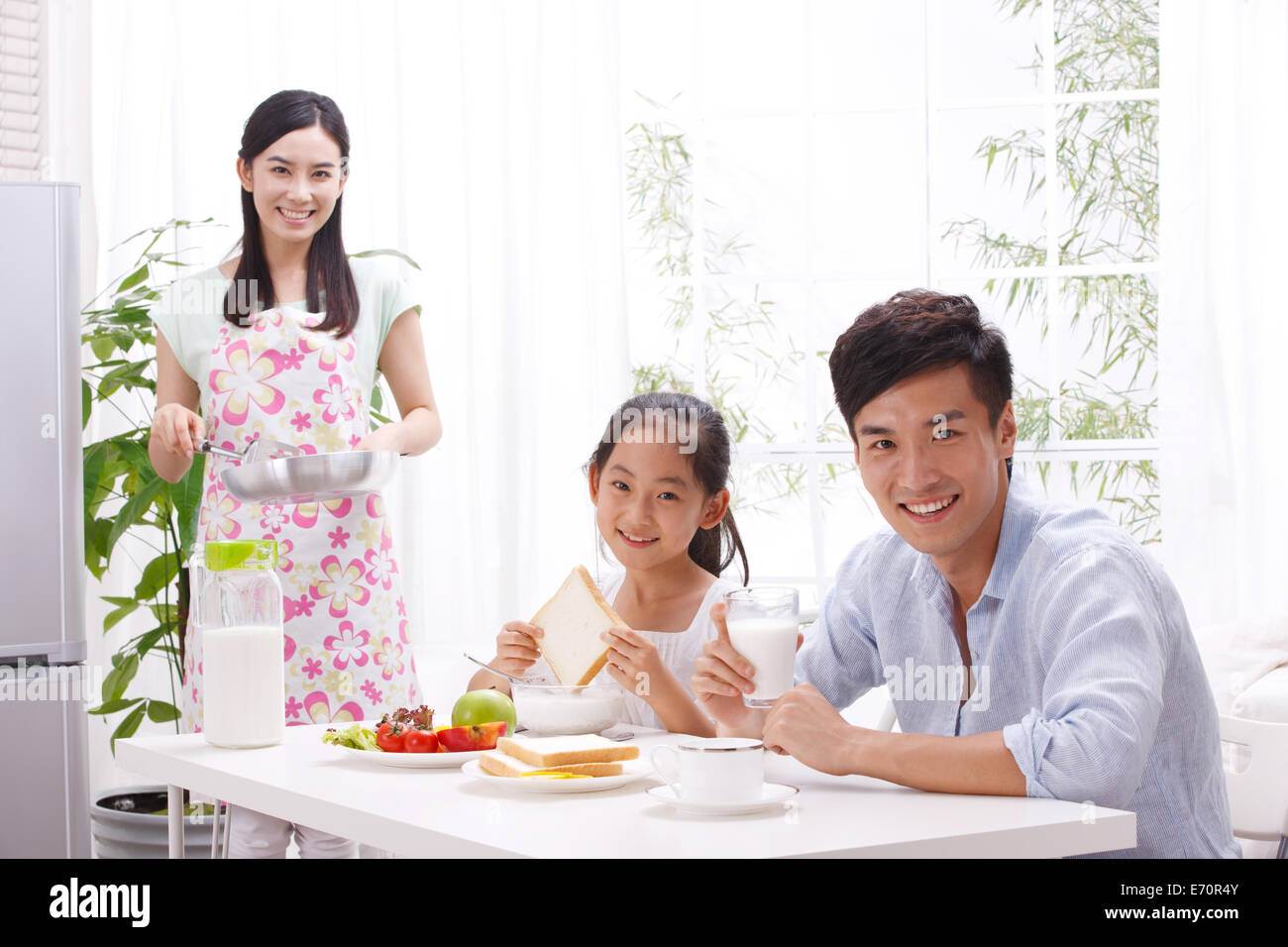 Family eating in kitchen Stock Photo - Alamy