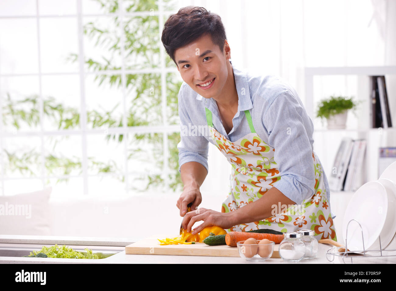 Young man cooking in kitchen Stock Photo - Alamy