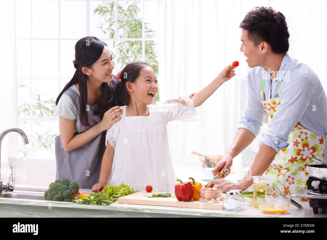 Family cooking in kitchen Stock Photo - Alamy