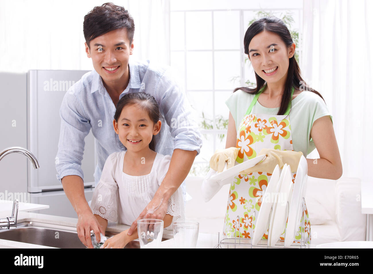 Family washing dishes in kitchen Stock Photo - Alamy