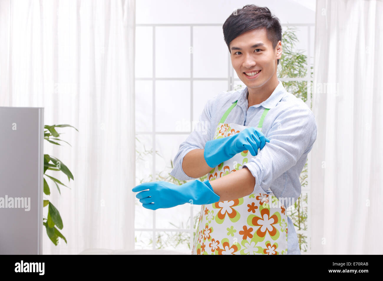 Young man cleaning room Stock Photo - Alamy