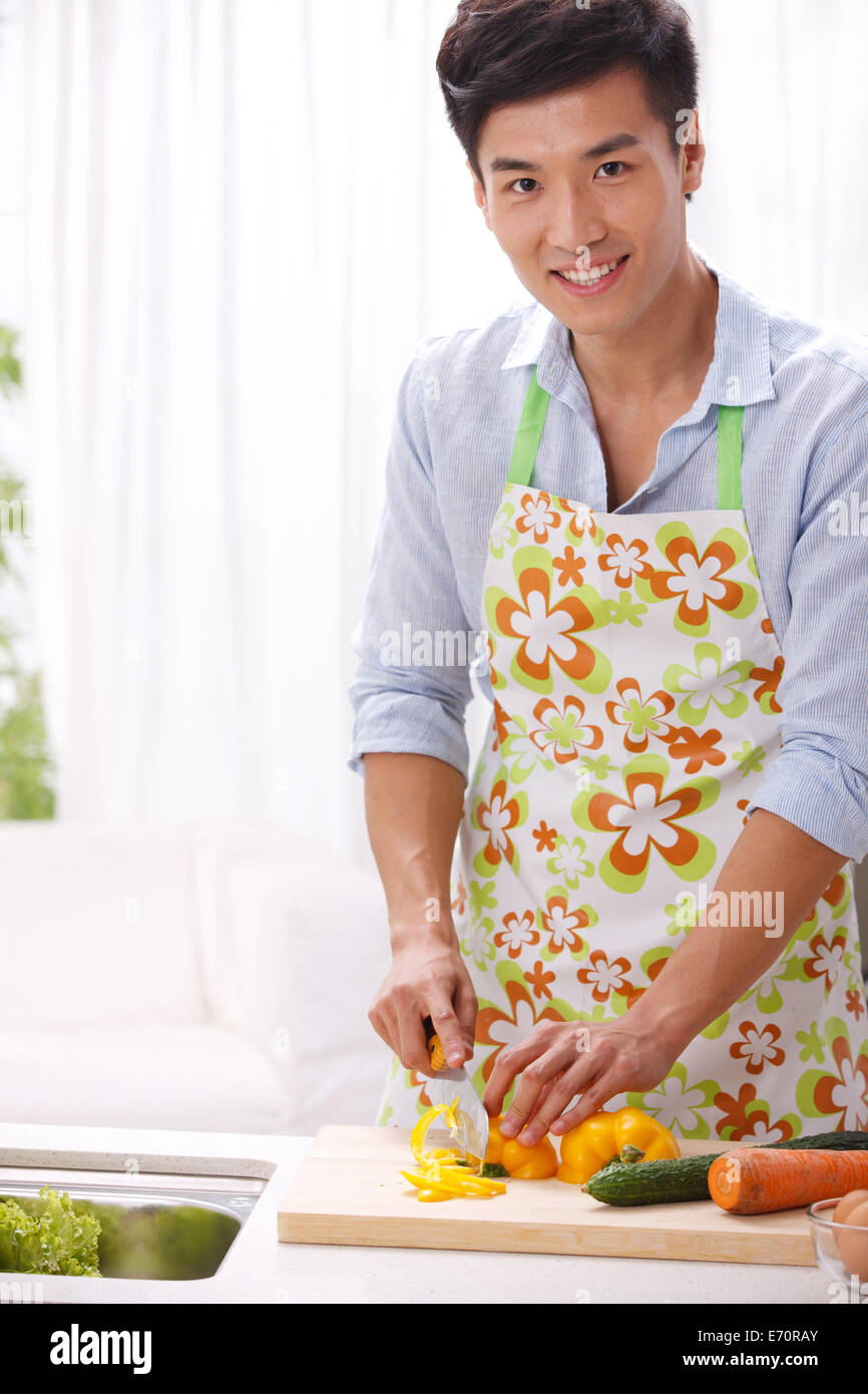 Young man cooking in kitchen Stock Photo - Alamy