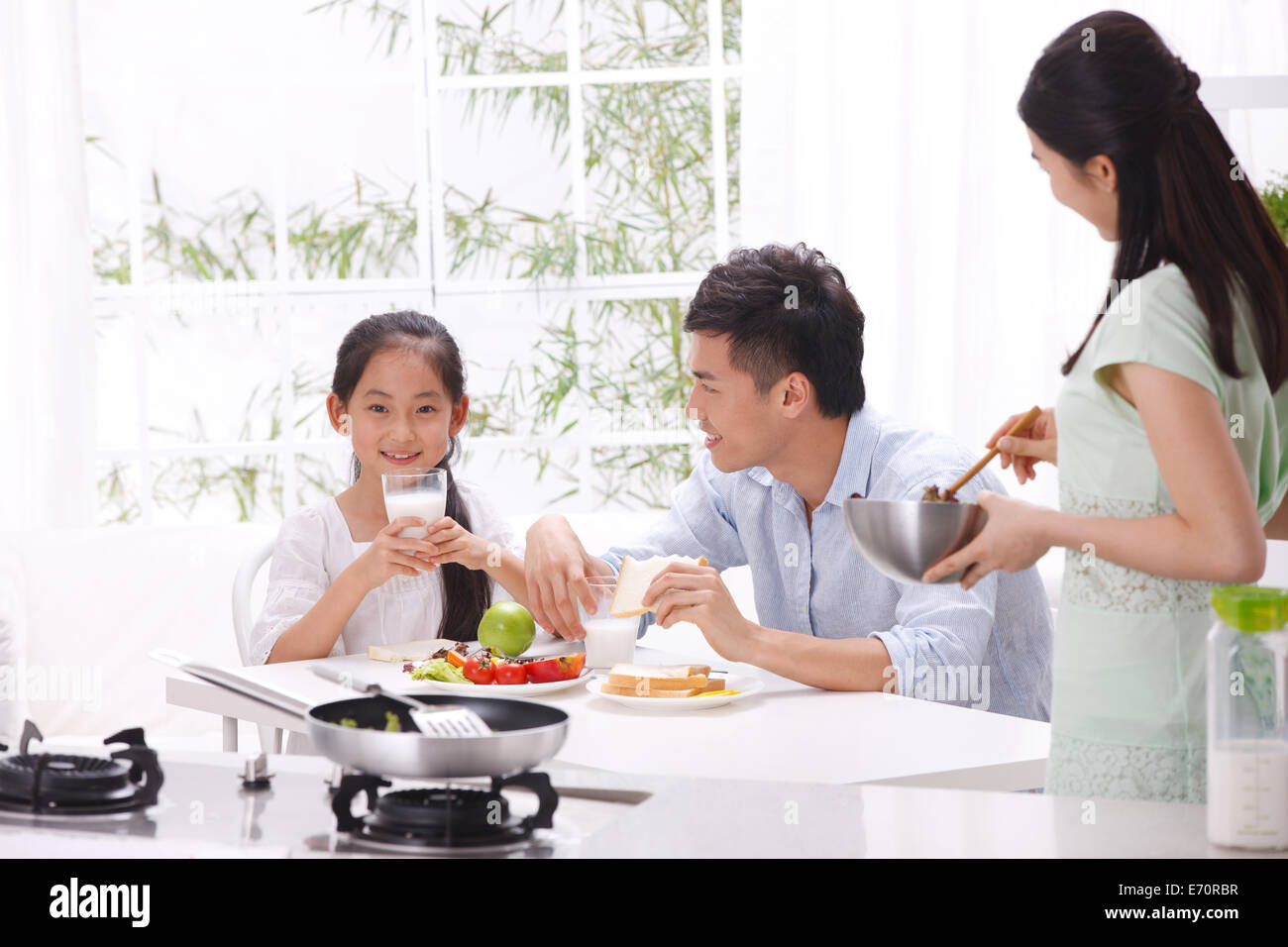 Family eating in kitchen Stock Photo - Alamy