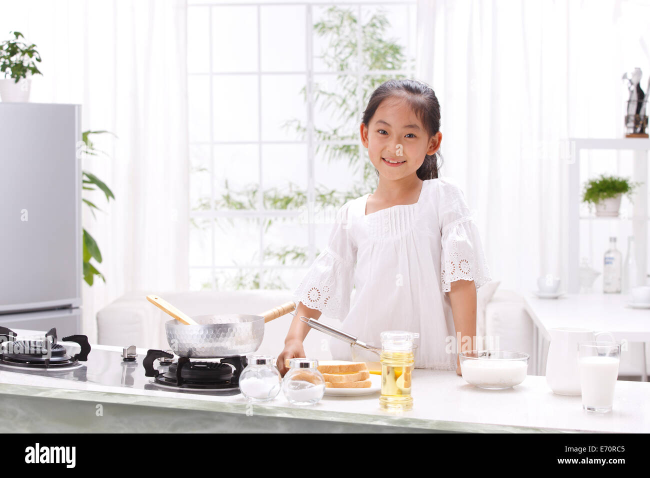 Girl in kitchen Stock Photo - Alamy