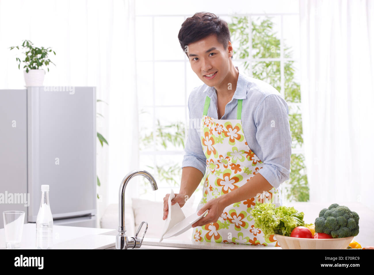 Young man washing dishes in kitchen Stock Photo - Alamy