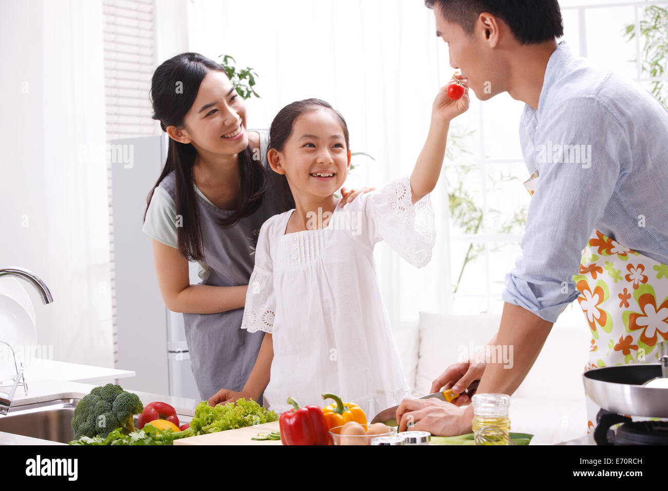 Family cooking in kitchen Stock Photo - Alamy