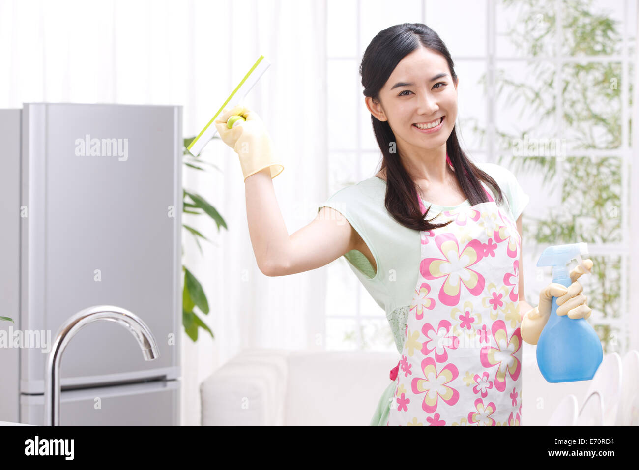 Young woman cleaning kitchen Stock Photo - Alamy