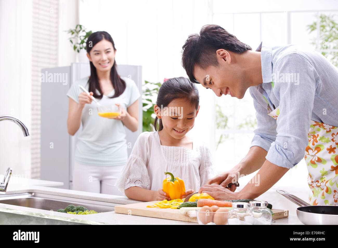 Family cooking in kitchen Stock Photo - Alamy