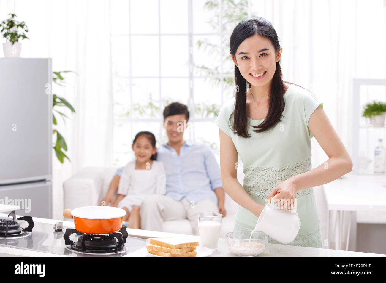 Family cooking breakfast in kitchen Stock Photo - Alamy