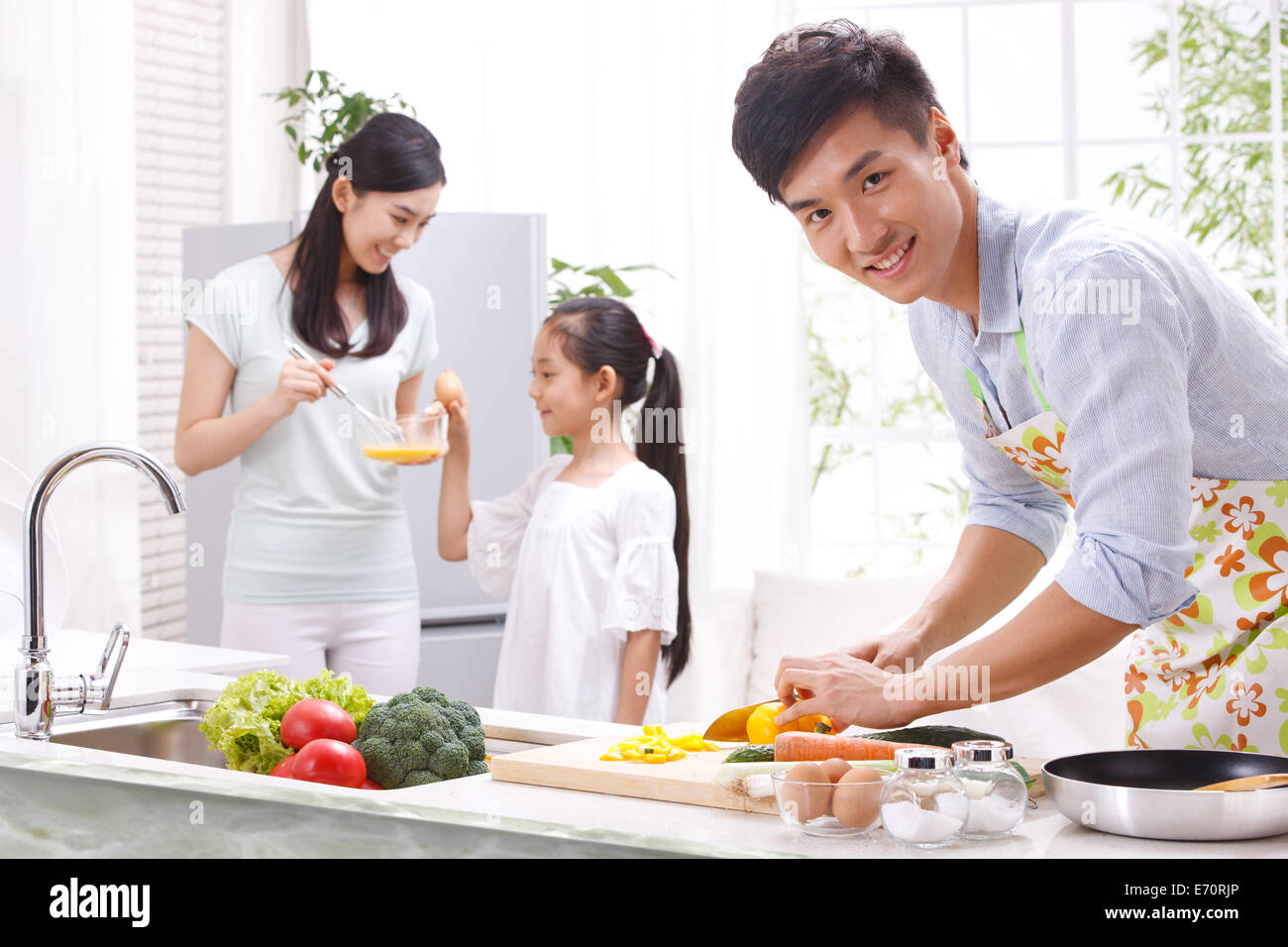 Family cooking in kitchen Stock Photo - Alamy