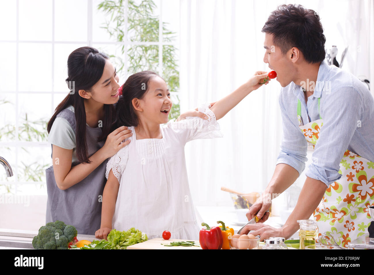 Family cooking in kitchen Stock Photo - Alamy
