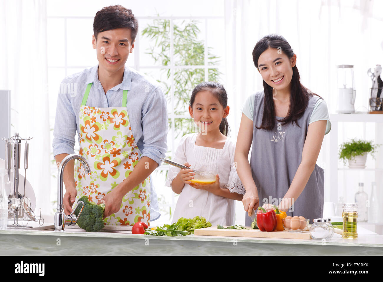 Family cooking in kitchen Stock Photo - Alamy