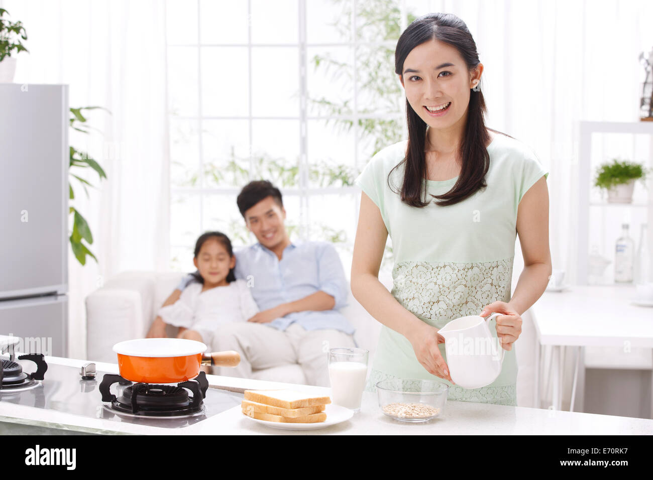 Family cooking breakfast in kitchen Stock Photo - Alamy
