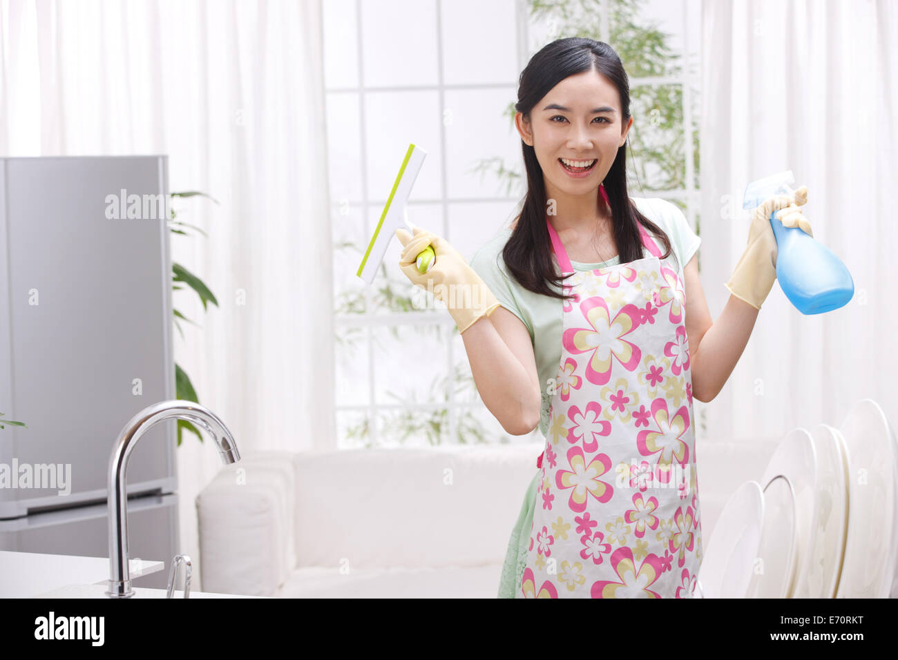 Young woman cleaning kitchen Stock Photo - Alamy