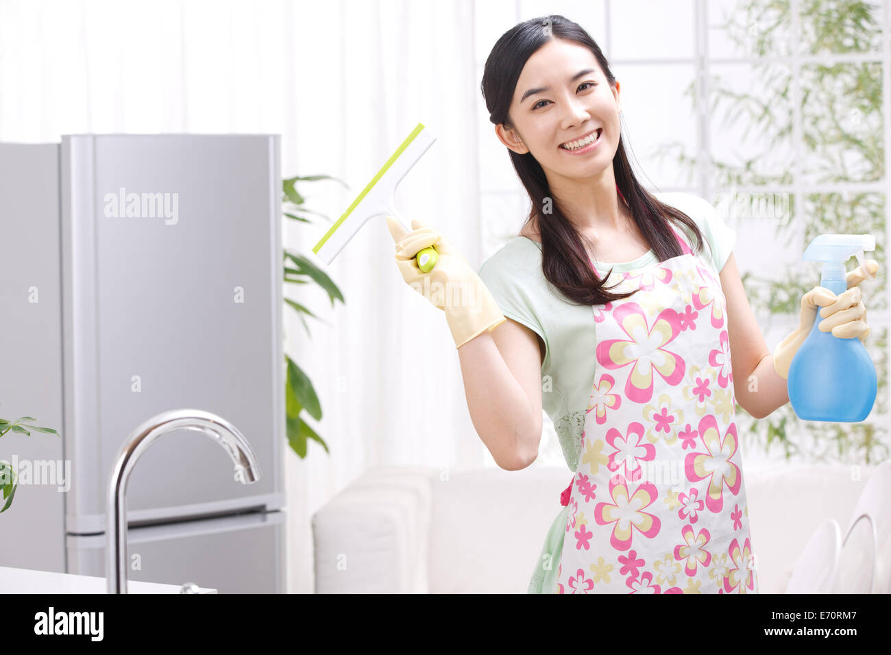 Young woman cleaning kitchen Stock Photo - Alamy