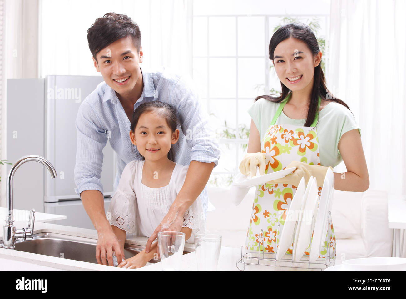 Family washing dishes in kitchen Stock Photo - Alamy