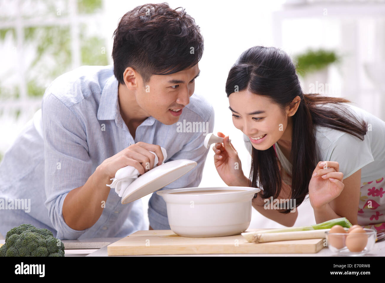 Young couple cooking in kitchen Stock Photo - Alamy